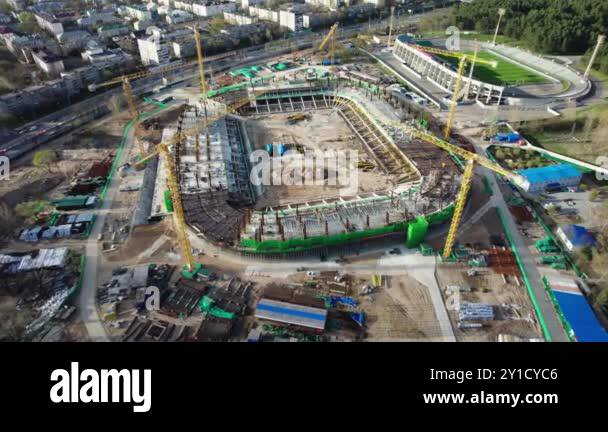 Building a football sports stadium. Construction site cranes and ...