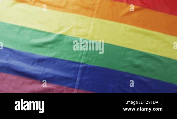 PRIDE text animation over rainbow flag background, celebrating LGBTQ+ ...