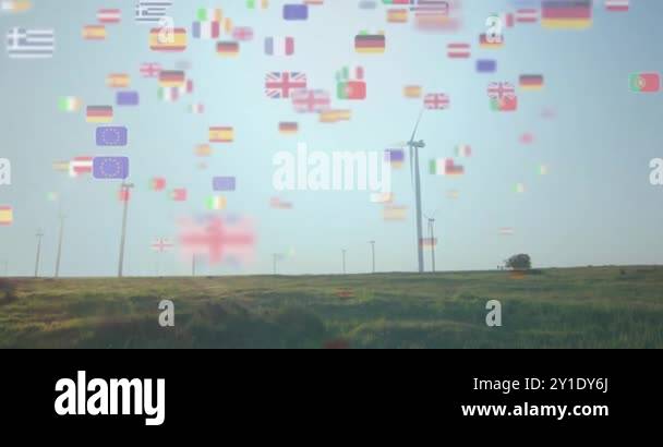 Wind turbines on grassy field with floating international flags ...