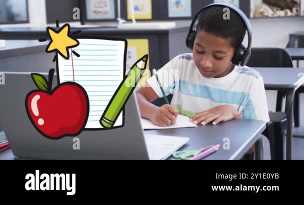 Studying at desk, child wearing headphones with school supplies ...