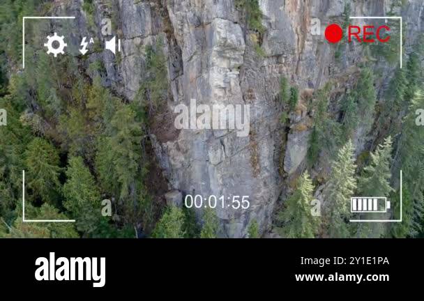 Recording animation over rocky cliff with trees and greenery. Nature ...