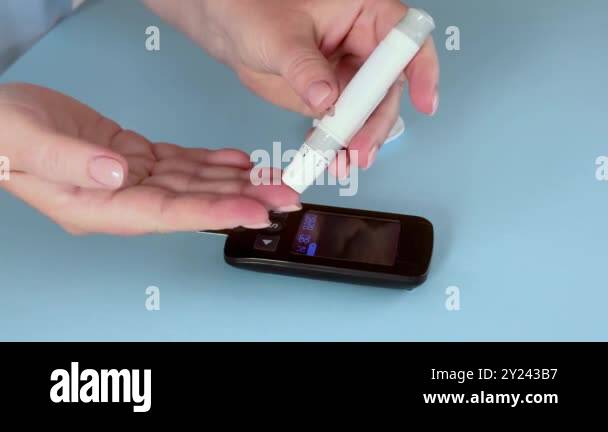 Diabetes monitoring concept. Woman using glucometer for checking blood ...