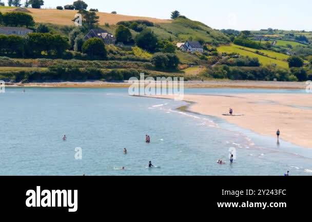 County Cork, Ireland, August 11, 2022. A long, narrow beach with light ...