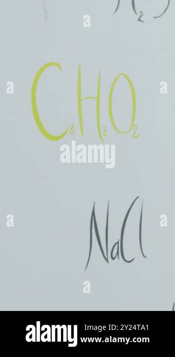 Colorful formulas of the chemical elements on white wall. Chemical ...