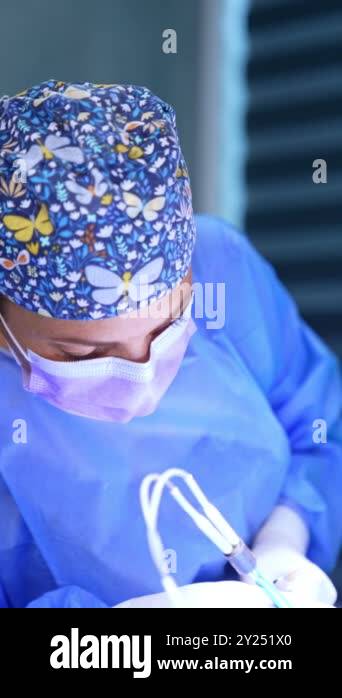 Female surgery professional wearing a cap with flowers and butterflies ...
