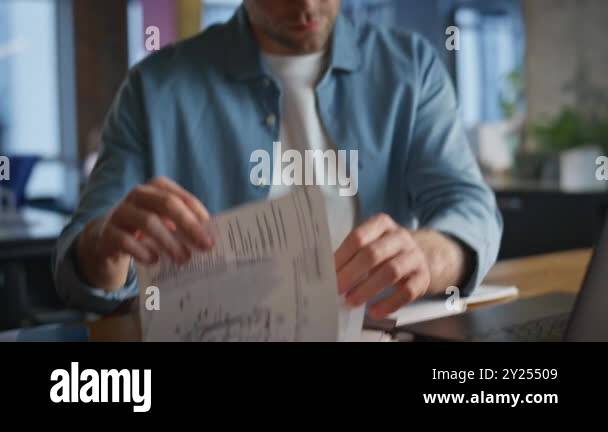Accountant hands reviewing paperwork coordinating tasks on laptop ...