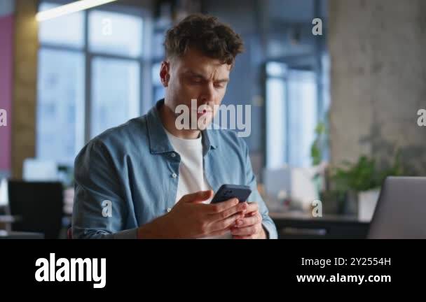 Exhausted businessman checking mobile phone notification reacting bad ...