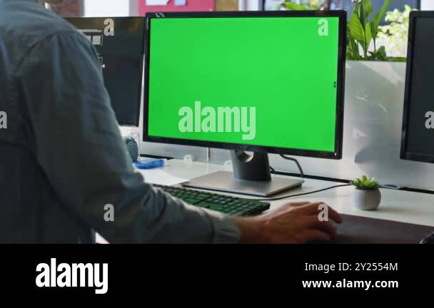 Office guy using chromakey computer closeup. Worker hand holding mouse device working green ...