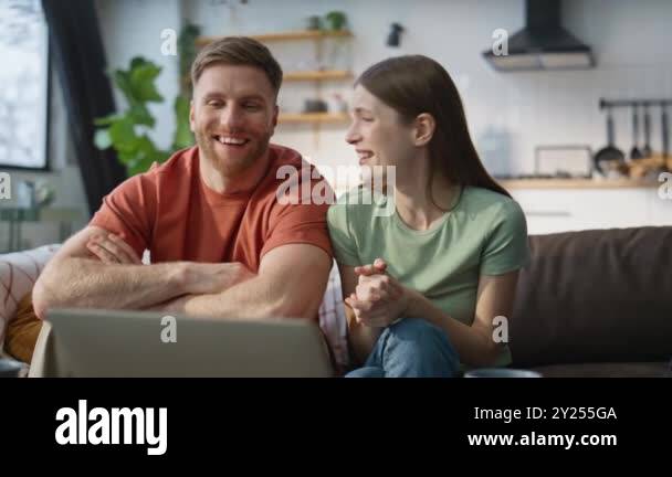 Spouses talking online meeting by laptop sitting home couch closeup ...