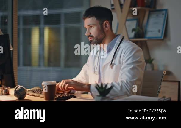 Doctor checking medical documents during night shift. Closeup tired ...