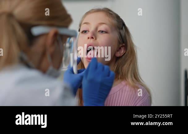 Pediatrician taking child swab test in clinic closeup. Cute child ...