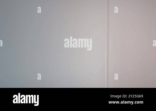 A modern interior scene featuring a person opening a door, revealing a ...