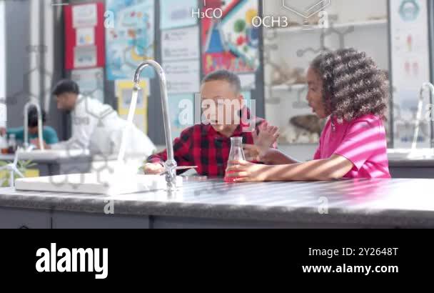 Children conducting science experiment with chemical formulas over classroom background ...