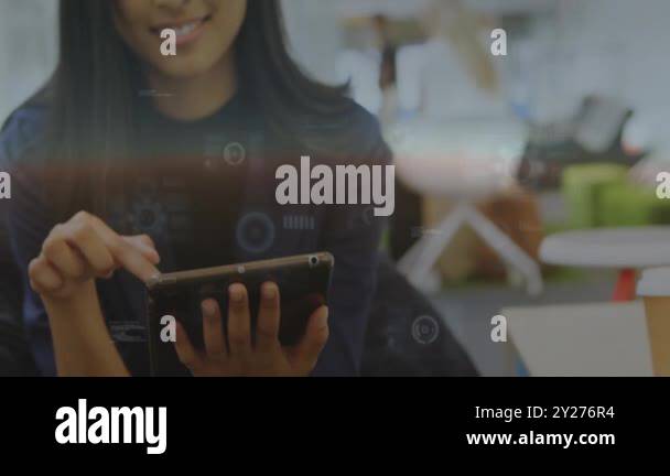 Using tablet, woman interacting with futuristic digital interface animations. Technology ...