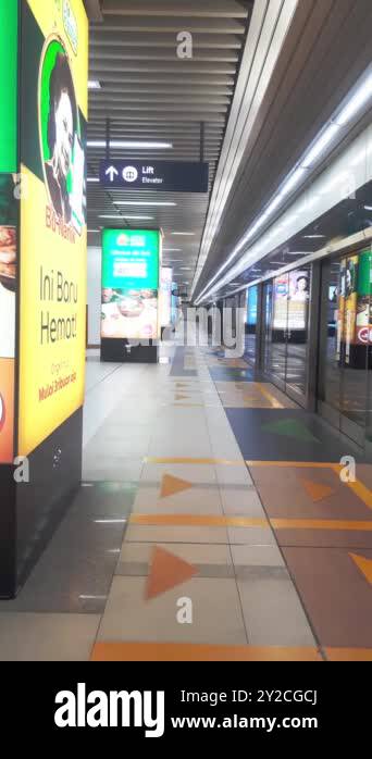 Empty platform in the mrt railway station in the mid day with billboard ...