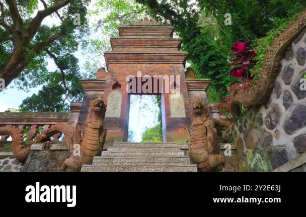 A beautiful entrance gate featuring intricate stone carvings and two ...