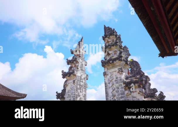 Two ornate stone towers with intricate carvings, set against a bright ...