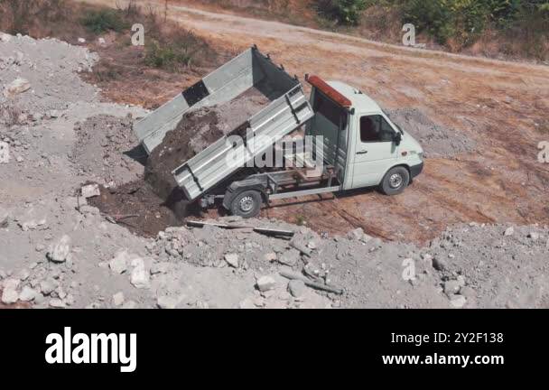 Small dump truck removes soil from a new construction site. Digging a ...