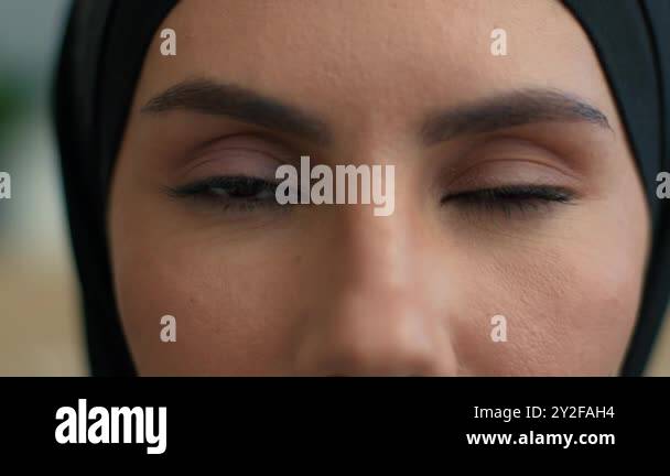 Close up macro extreme eyes woman Muslim islamic female in hijab arabic girl eye opening stare ...