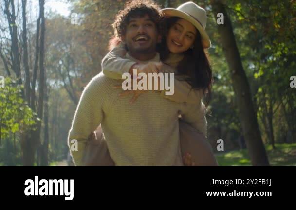 Carefree loving Indian Arabic couple smiling man boyfriend boy carry ...