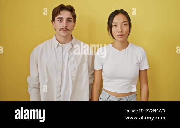 Excited chinese-hispanic interracial couple standing proud, screaming ...