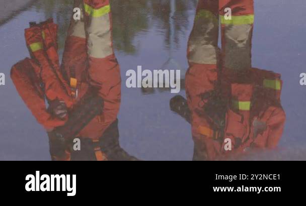 A group of prepared firefighters stands ready for hazardous tasks ...