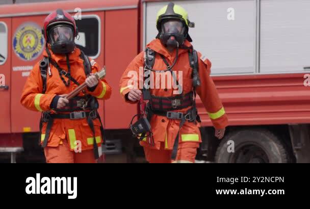 A group of prepared firefighters stands ready for hazardous tasks ...