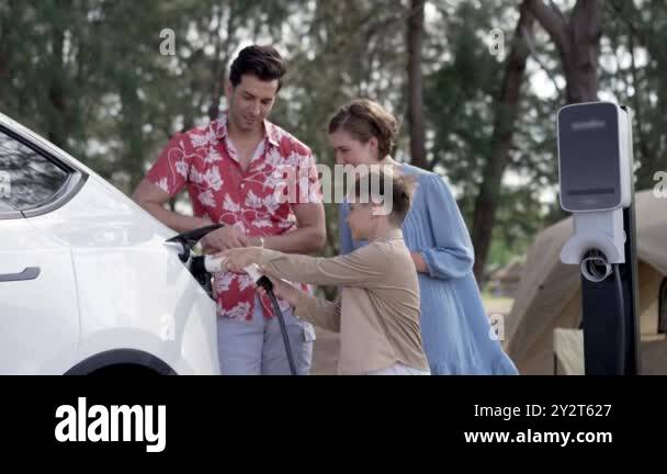 Outdoor adventure and family vacation camping in nature travel by eco friendly car for ...