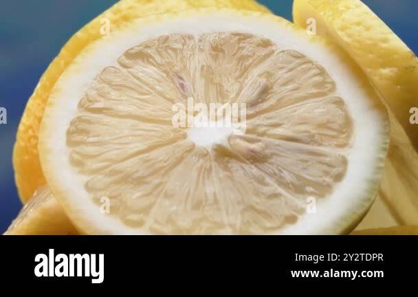 A slice of fresh lemon, bright yellow and vibrantly citric, lies ...