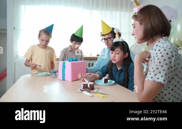 Attractive family celebrate daughter birthday while talking at modern ...