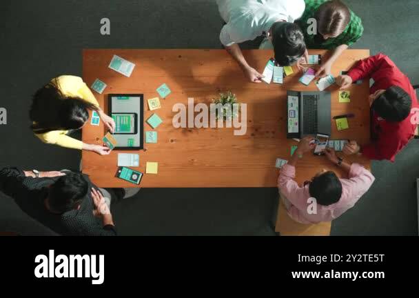 Programmer team brainstorm and plan Ux Ui design for mobile phone while present idea by using ...