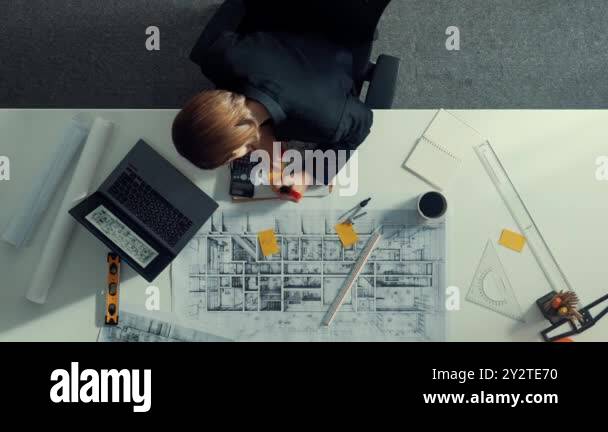 Architect engineer working while working on laptop with sticky notes ...