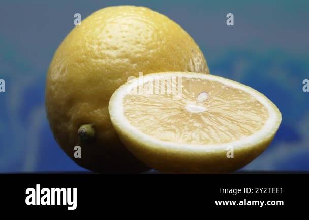 A slice of fresh lemon, bright yellow and vibrantly citric, lies ...