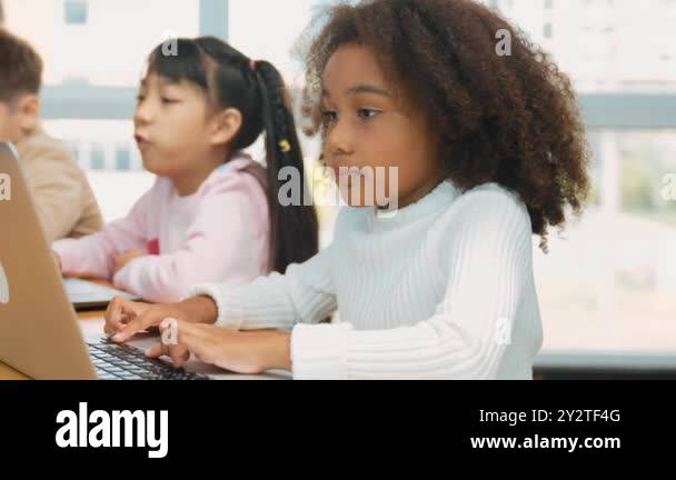 African girl play laptop with diverse friend learning prompt at STEM technology class ...