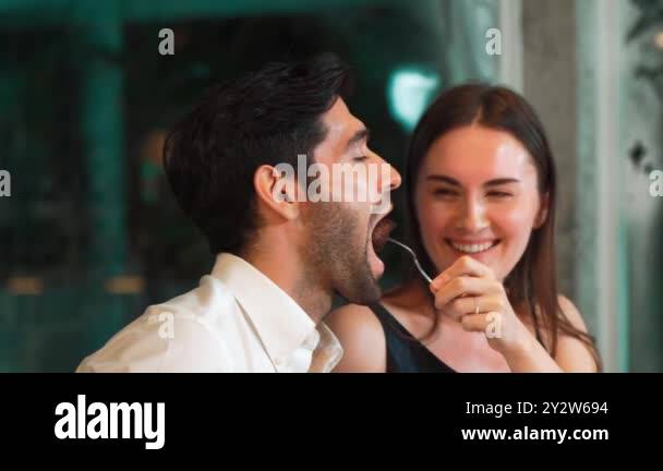 Couple having dinner sharing grilled meat together in special meal at ...