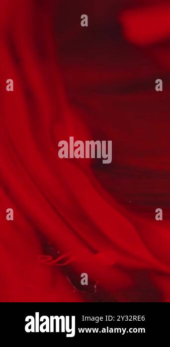 Vertical video. Paint water splash. Color mist. Blur bright red smoke ...