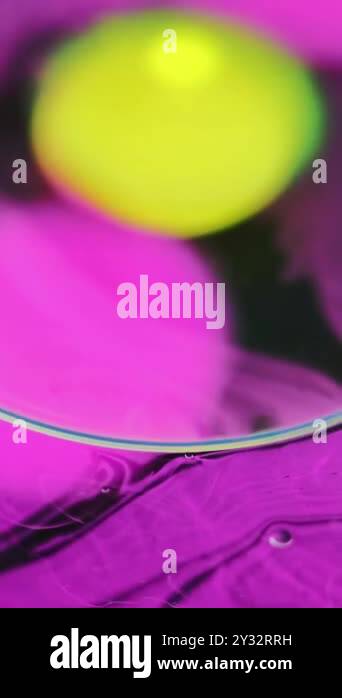 Vertical video. Oil blob. Ink water mix. Color mist. Defocused neon ...