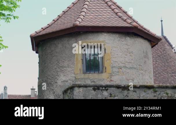 Old stone tower with a barred window in a medieval castle, showcasing ...