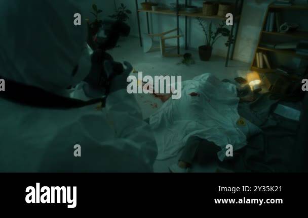 Forensic photographer taking pictures of murdered victim covered with ...