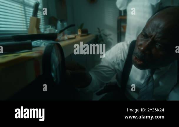 African American detective examining bloody handprint on kitchen ...