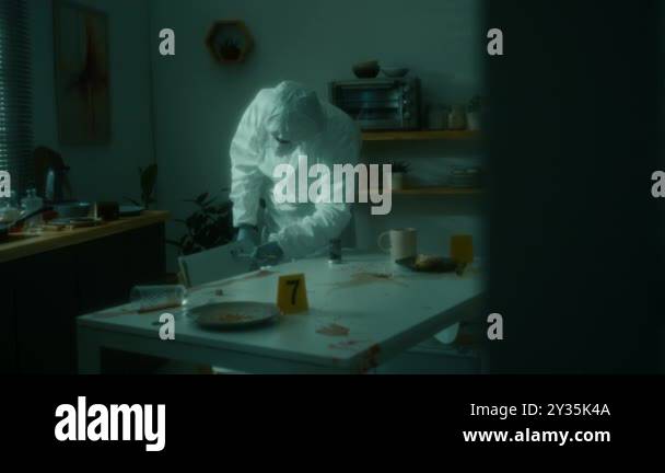 Forensic investigator in protective suit dusting chair for fingerprints ...