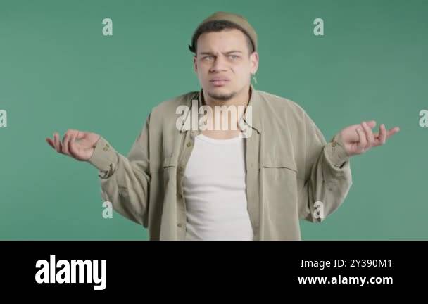 Confused biracial man, shoulders up - cant help, makes gesture of I ...