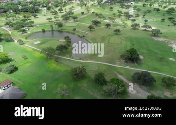 Pond water runoff, sand trap, grassy fairway, club car paths in country ...