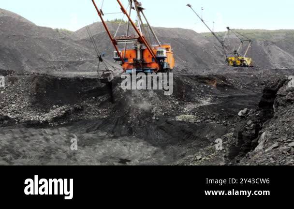 Excavation and heavy machinery are used at a coal mining site ...