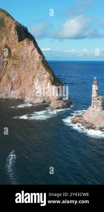 Top view of dramatic landscape of rocky island and lighthouse in sea ...