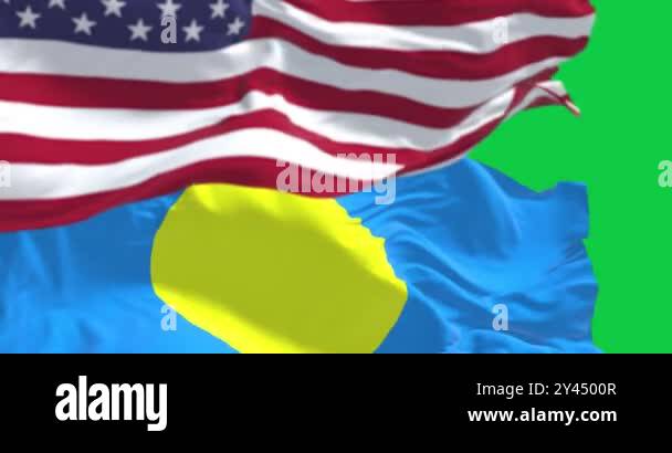 Close-up of Palau and american national flags waving iisolated on green ...
