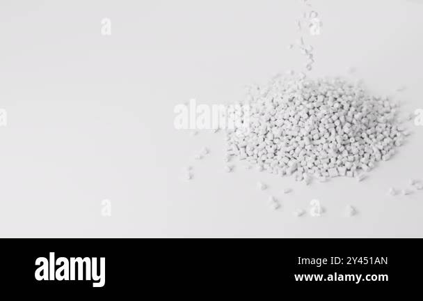 Black plastic polypropylene granules pouring from cup on a pile of ...