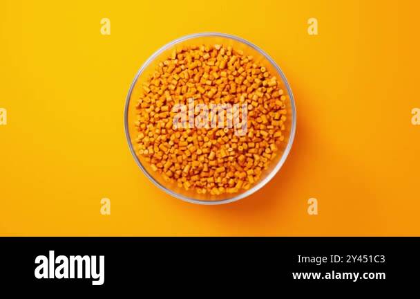 Rotating glass bowl with black plastic polypropylene granules ...