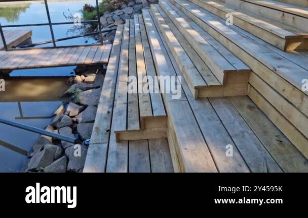 a floating jetty for mooring ships is fixed with metal rods on hinges ...