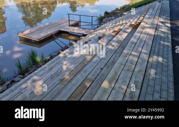 a floating jetty for mooring ships is fixed with metal rods on hinges ...